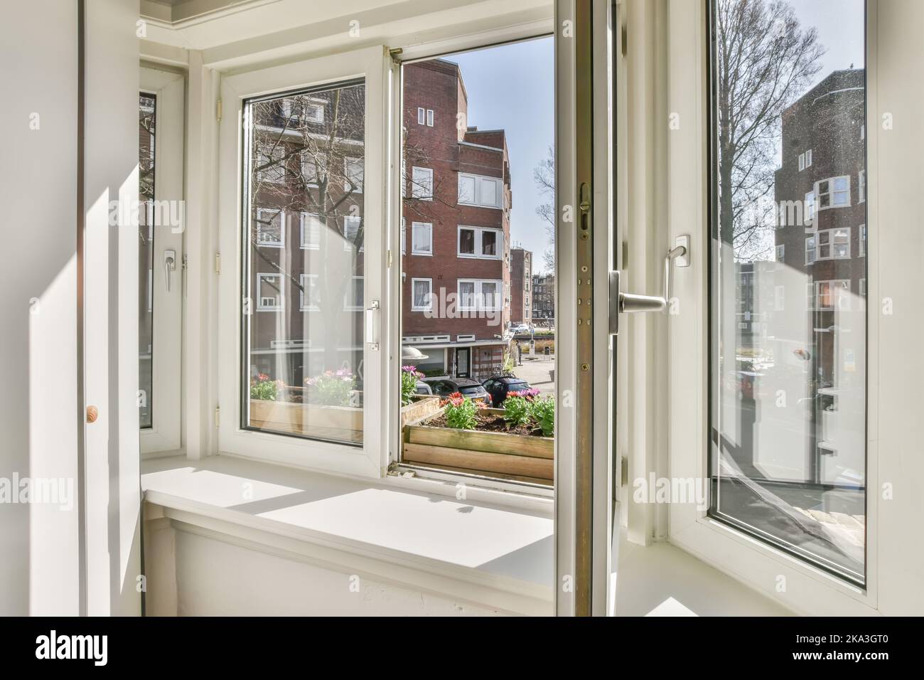 Big glass window with white frame and metal locks in light room ...