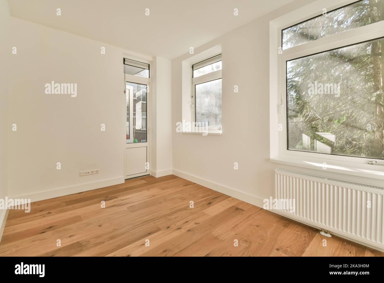 Interior of spacious empty unfurnished room with white walls and ...