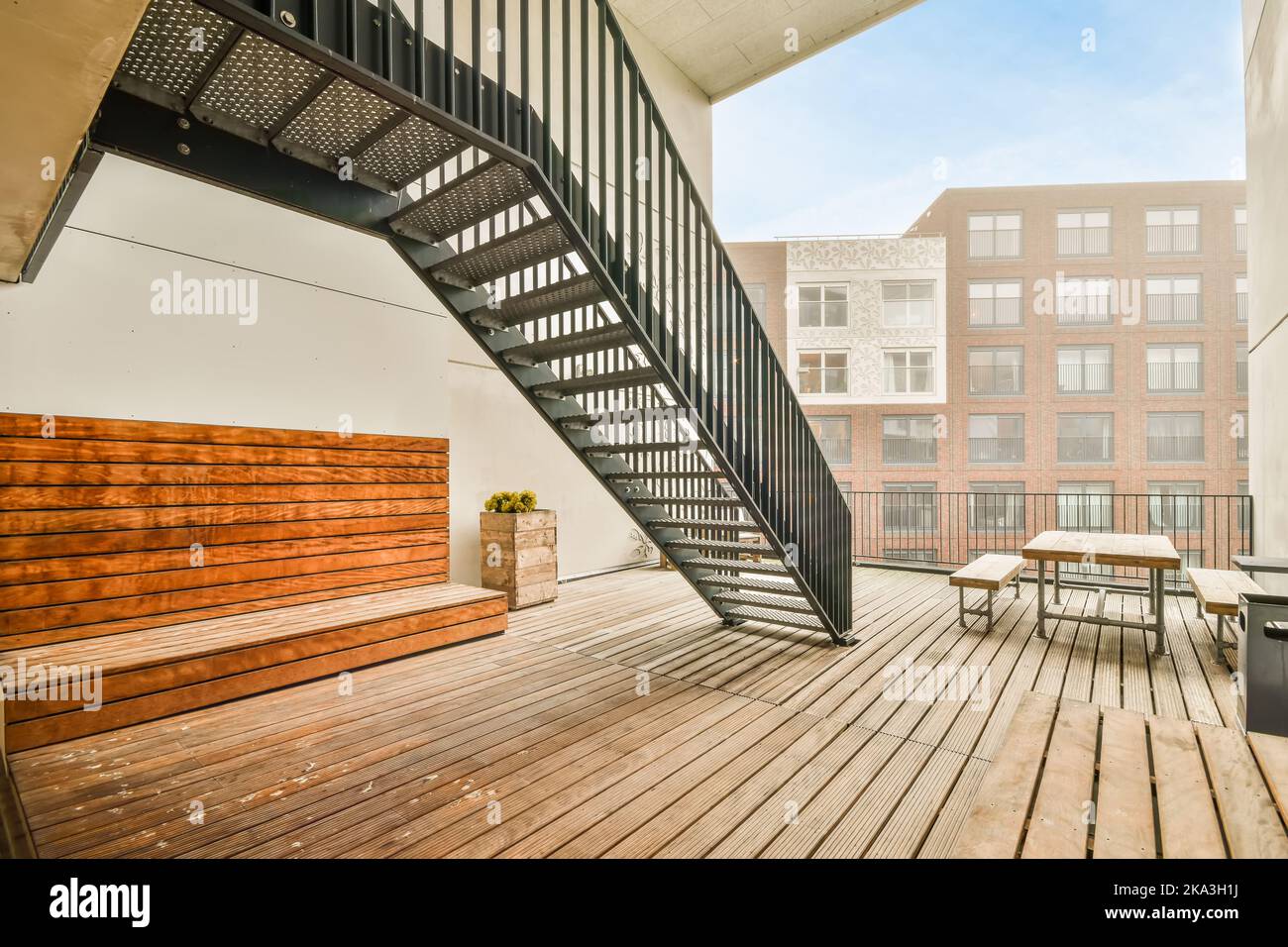 Large terrace with staircase and wooden bench and table on tiles ...