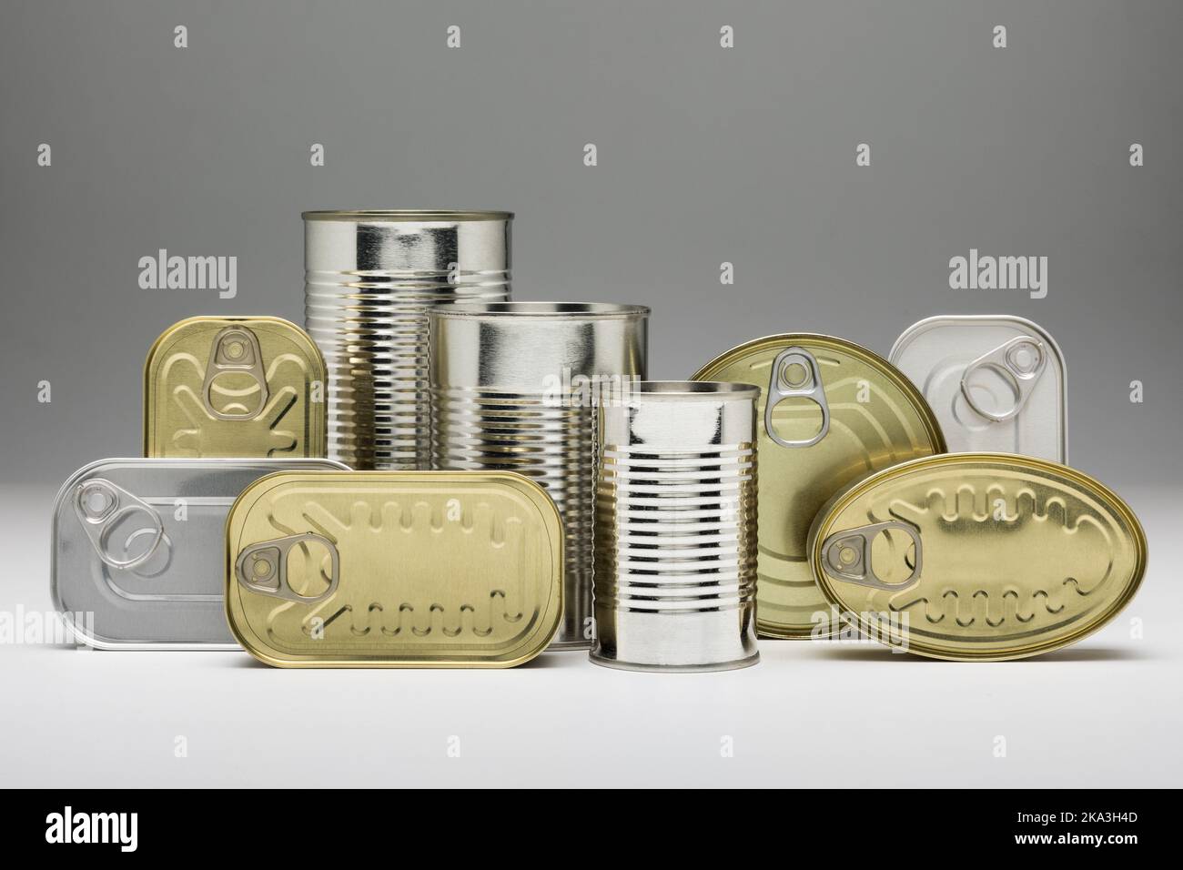 Stacked unopened metal cans on grey background Stock Photo - Alamy