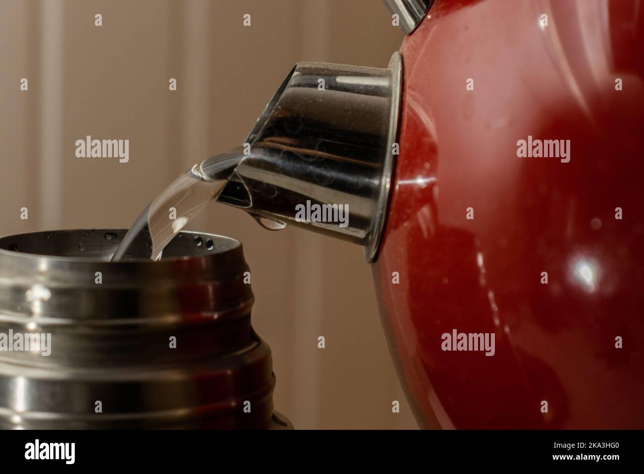 Transferring hot water from kettle to thermos for a mate Stock Photo ...
