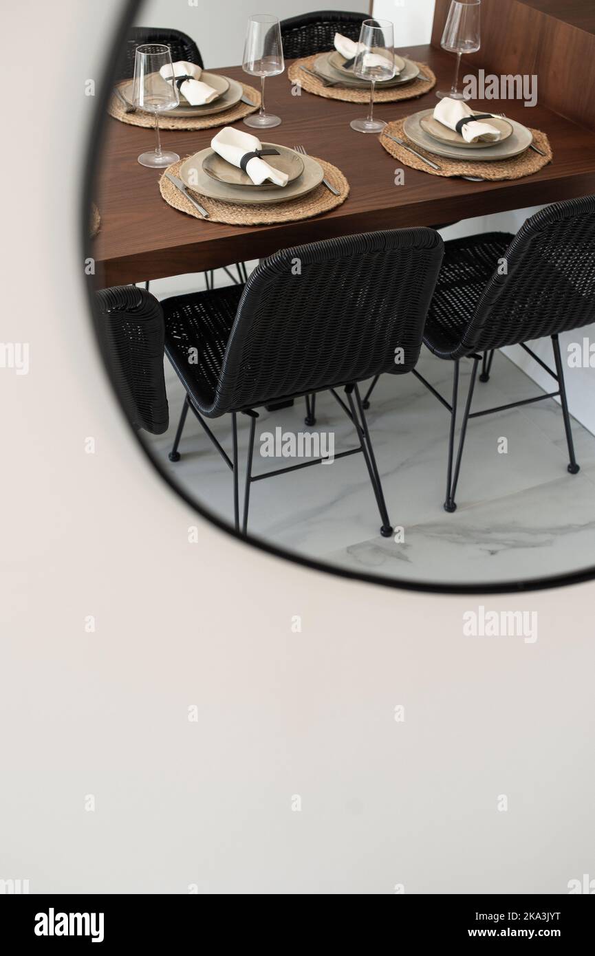 A reflection of a laid dining table seen in a mirror Stock Photo - Alamy