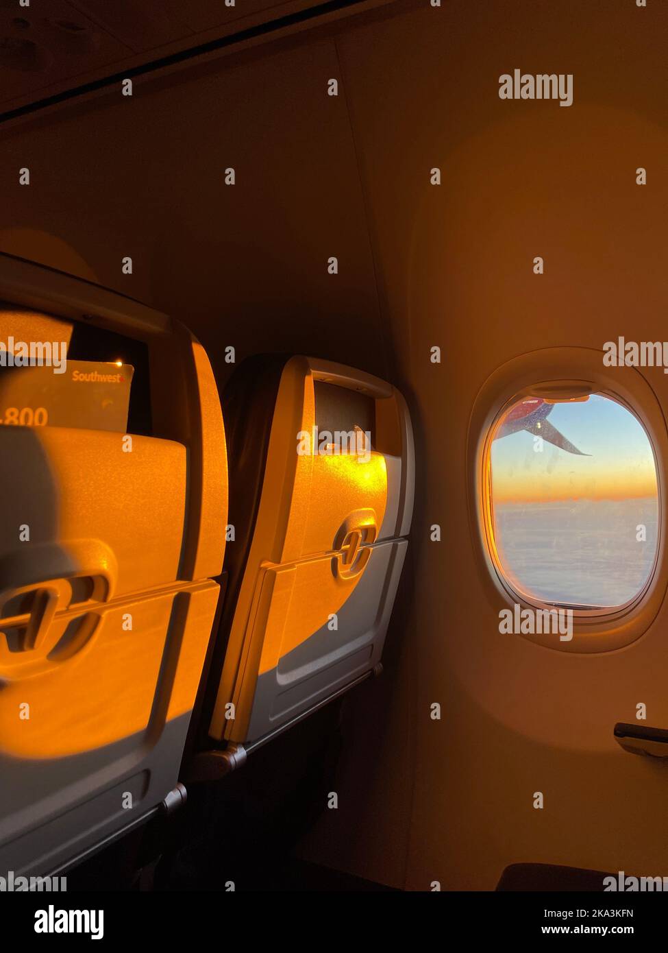 A view of plane interior with window and seats Stock Photo - Alamy