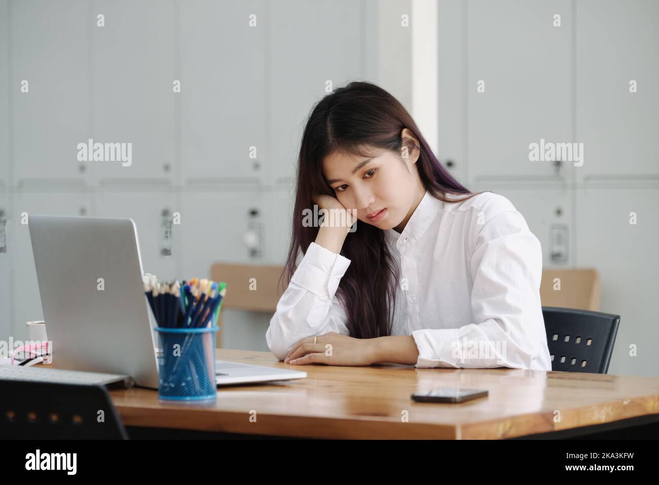 Employees show signs of boredom from working full time Stock Photo - Alamy