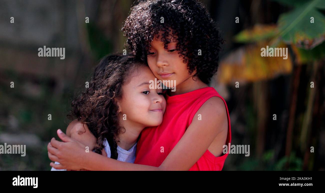 Children hugging each other. Two little hispanic girls embrace Stock ...