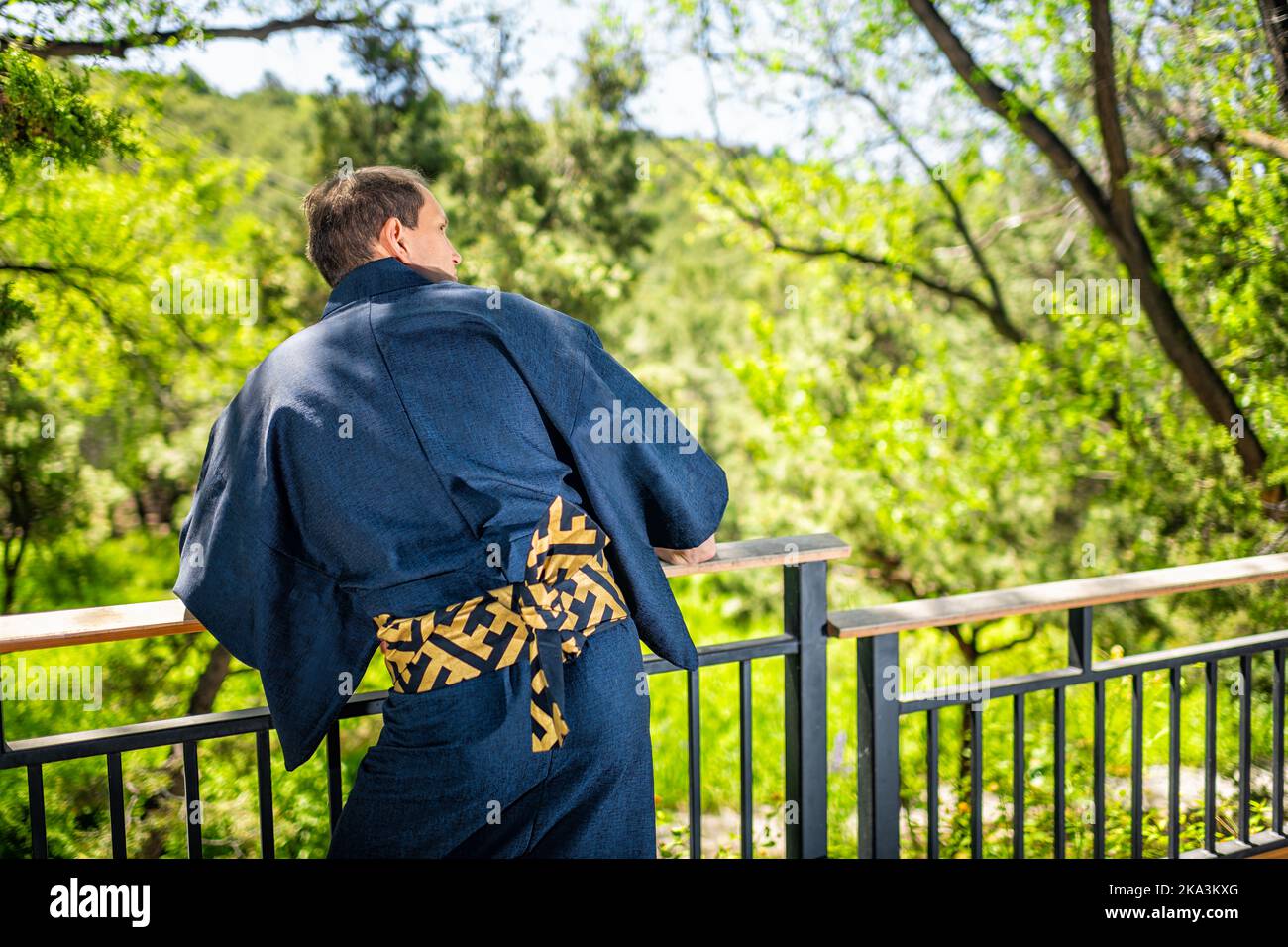 Young man in kimono costume traditional clothes standing with back ...