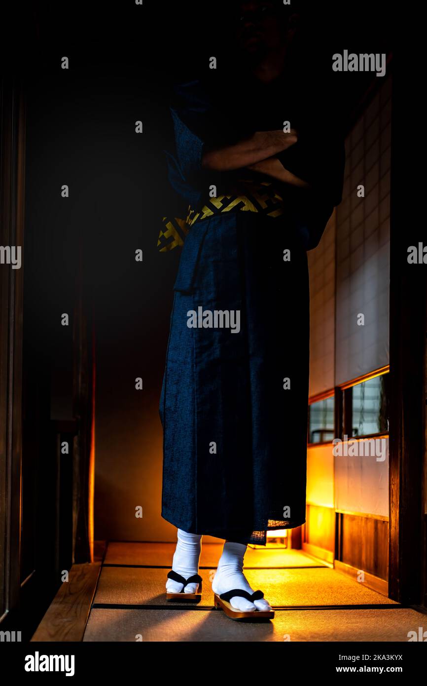 Man in Japanese kimono walking with geta socks on feet and tabi shoes ...