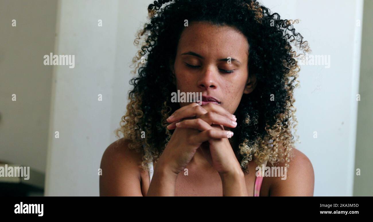 Lonely woman praying in hi-res stock photography and images - Alamy