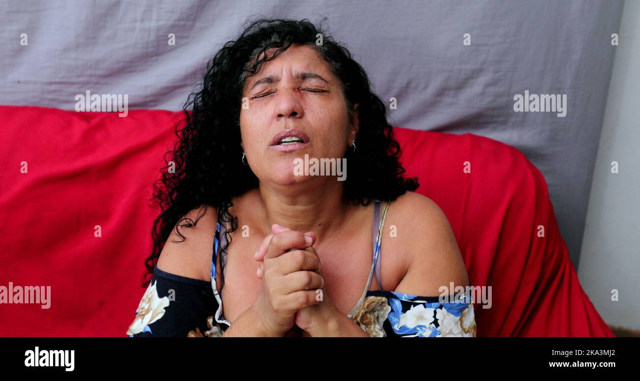 Evangelical Brazilian woman praying to God. Spiritual mature person ...
