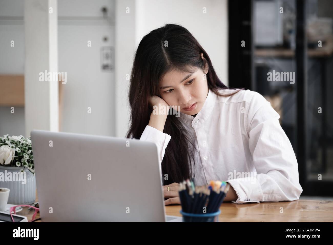 Employees show signs of boredom from working full time Stock Photo - Alamy