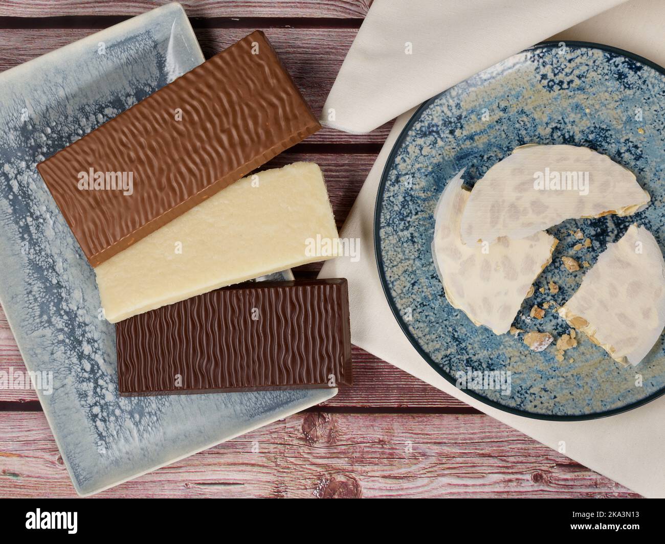 Different types of nougat in blue plates and trays Stock Photo - Alamy