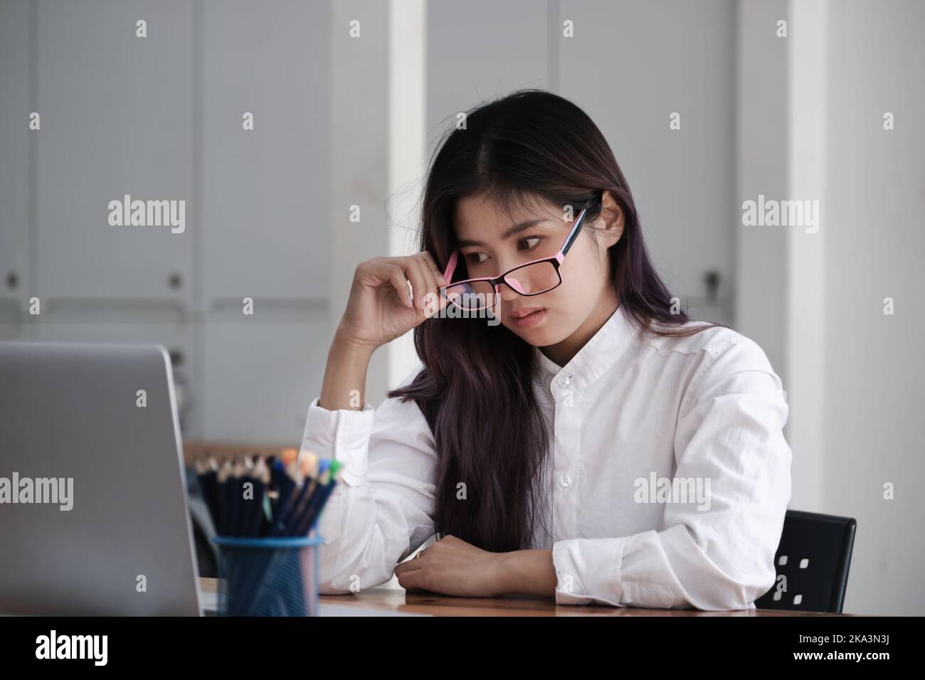 Employees show signs of boredom from working full time Stock Photo - Alamy