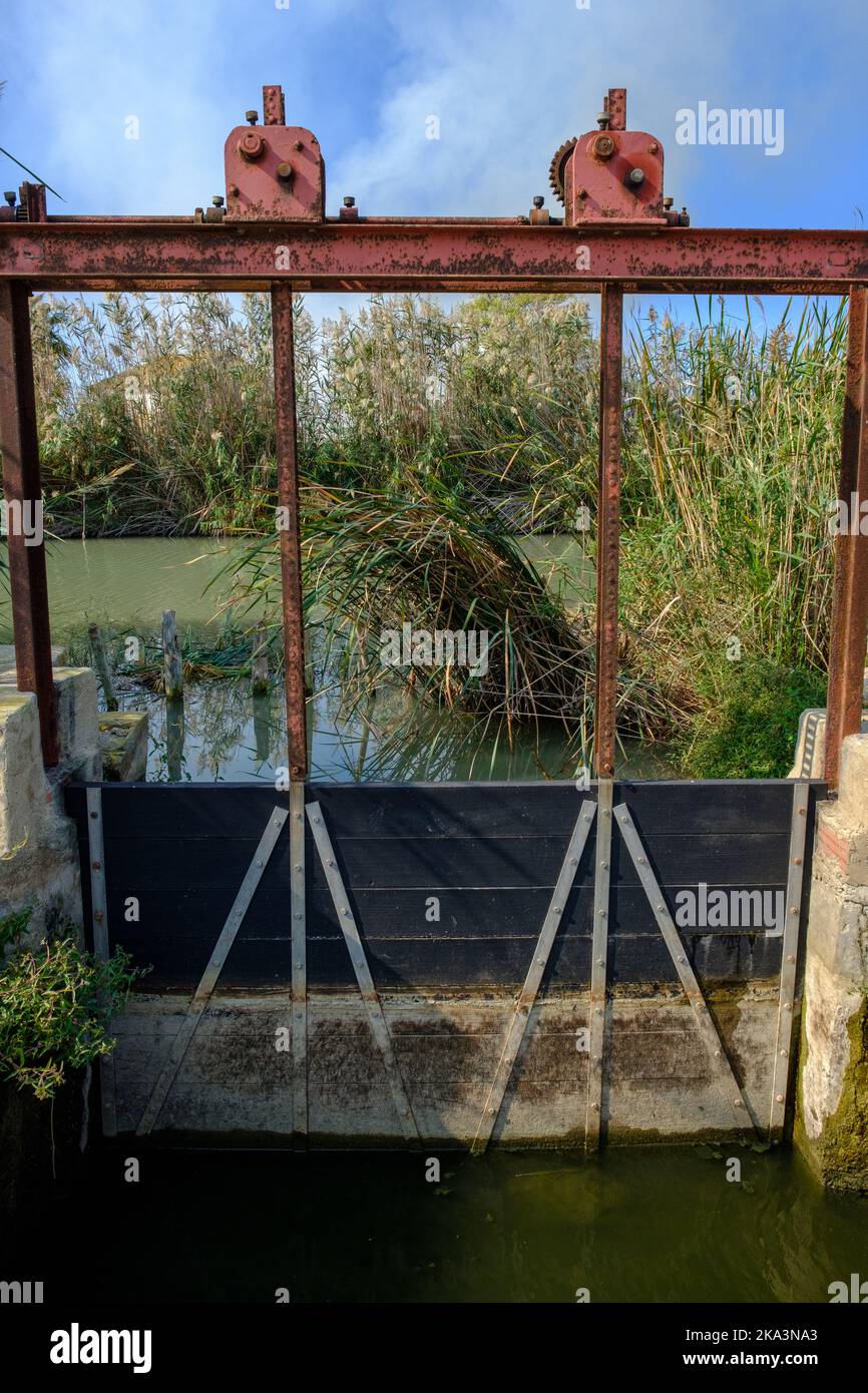 Wooden doors in irrigation ditch, to control entry and exit of water ...