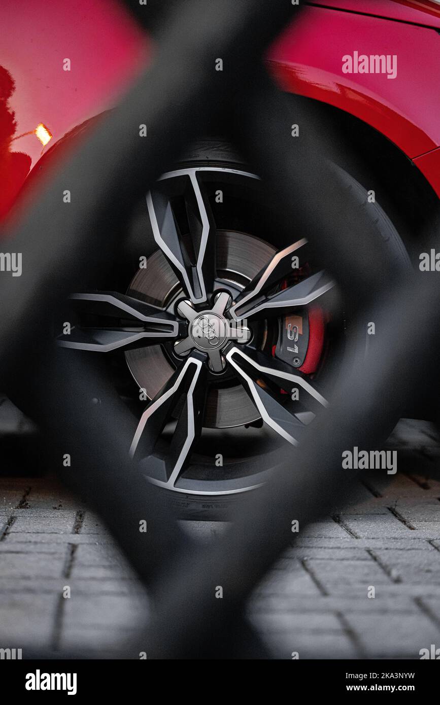 A red Audi rim through a fence Stock Photo - Alamy