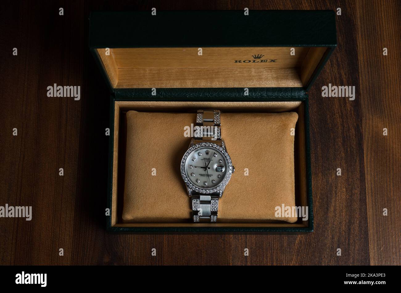 A top view of a Rolex in a green box on a wooden background Stock Photo ...