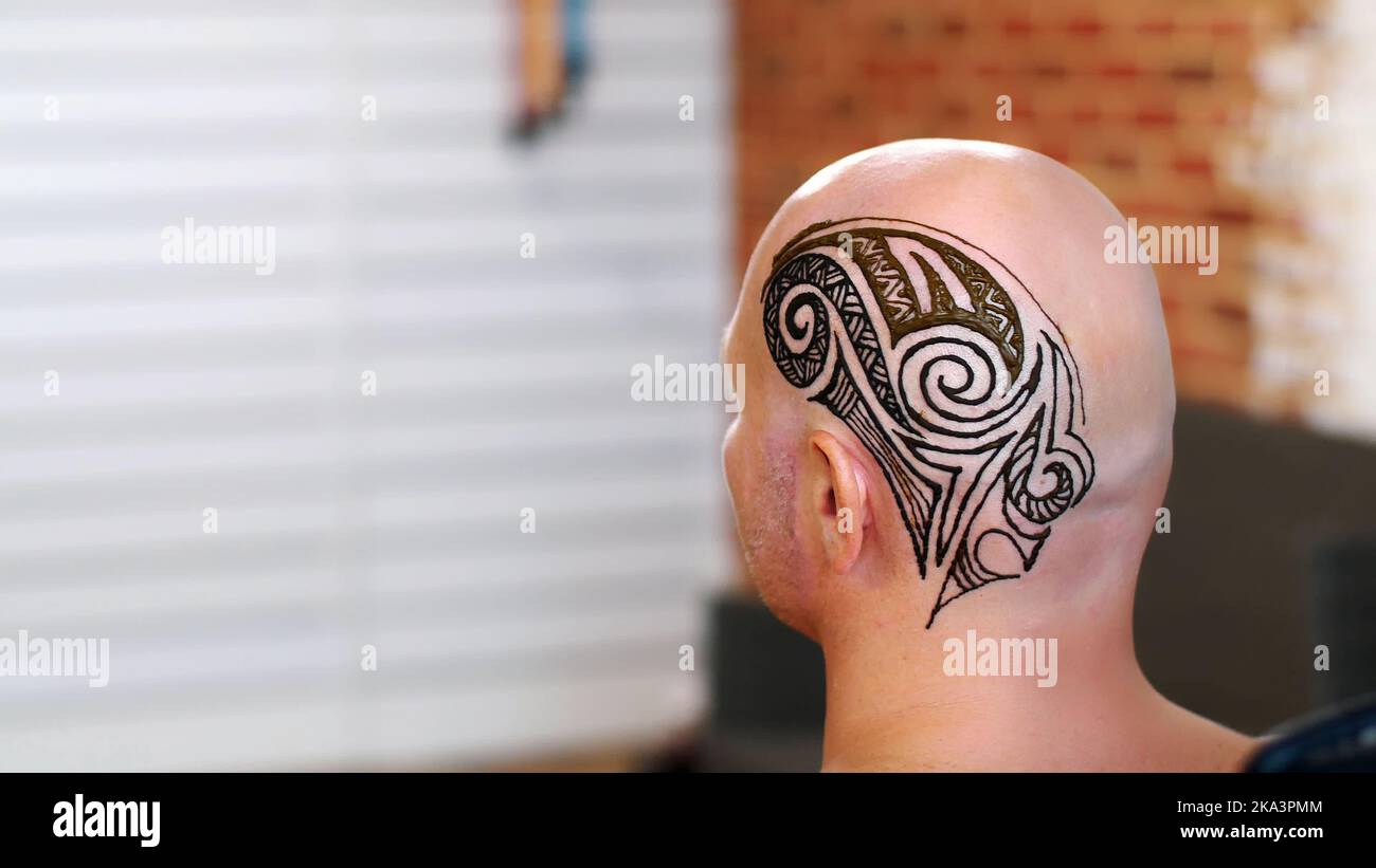 A close-up of the drawing, ornament, henna tattoo, on the scalp ...