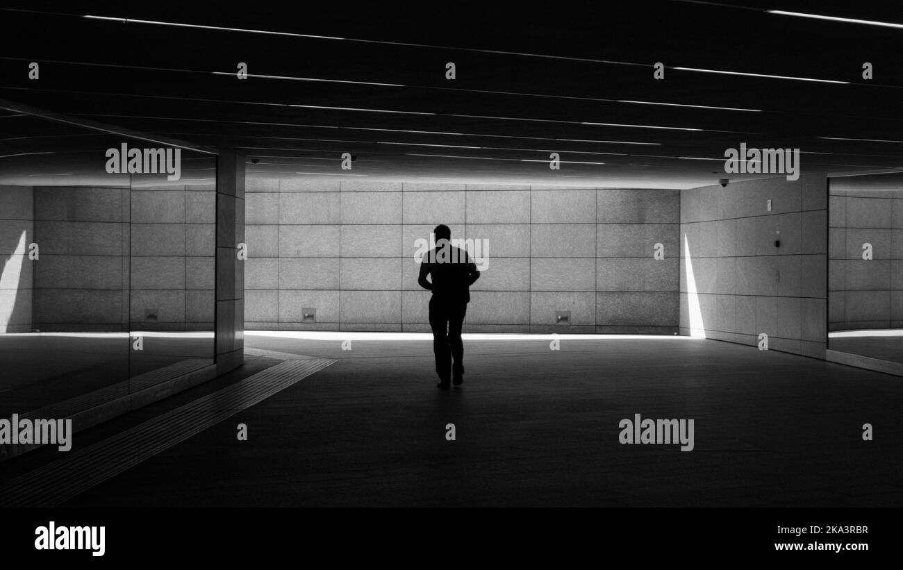 Man walking into a building Black and White Stock Photos & Images - Alamy