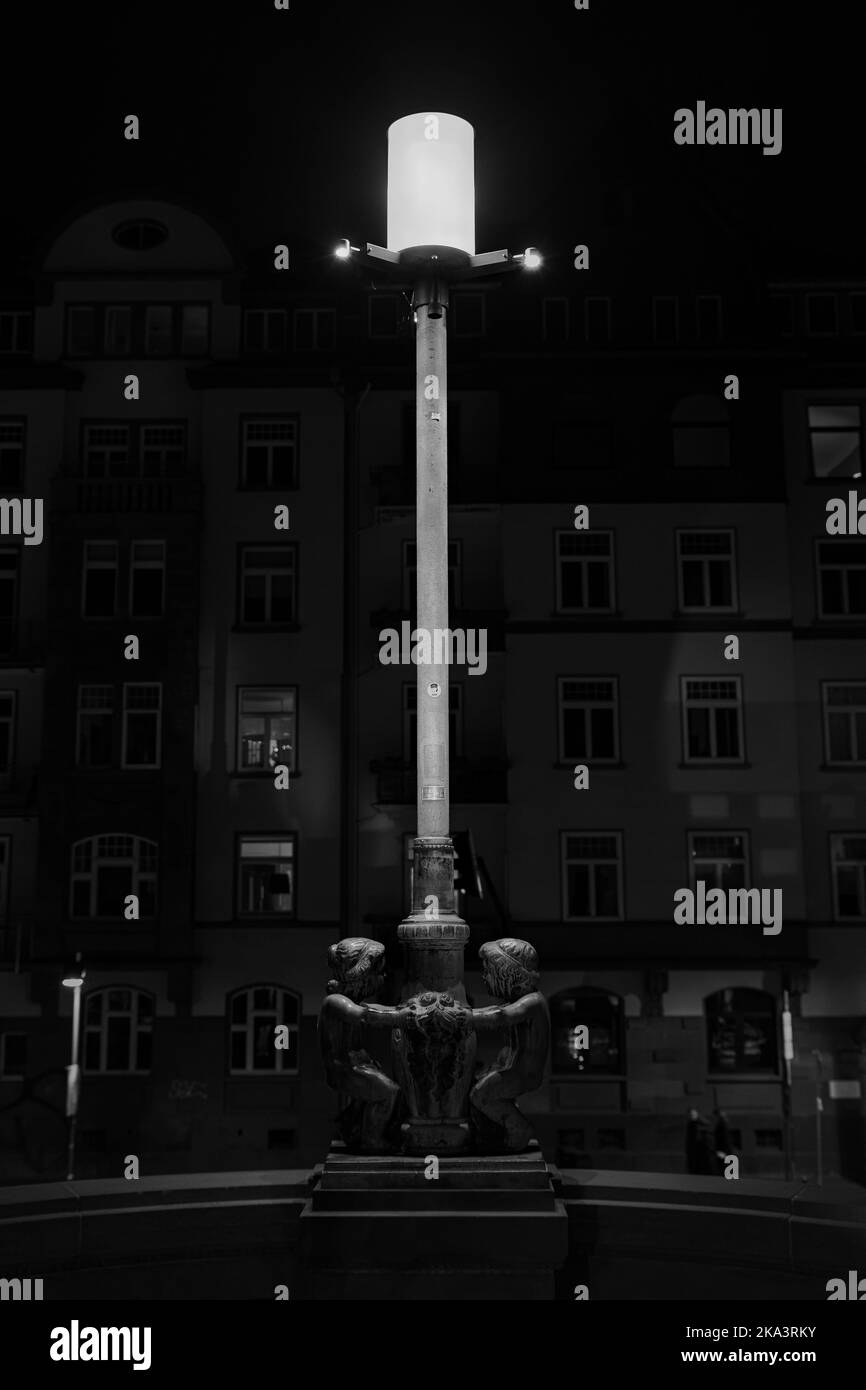 A street light with sculptures at night Stock Photo - Alamy