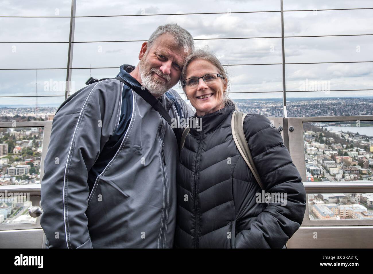 Smiling couple standing on Space Needle observation platform, Seattle ...