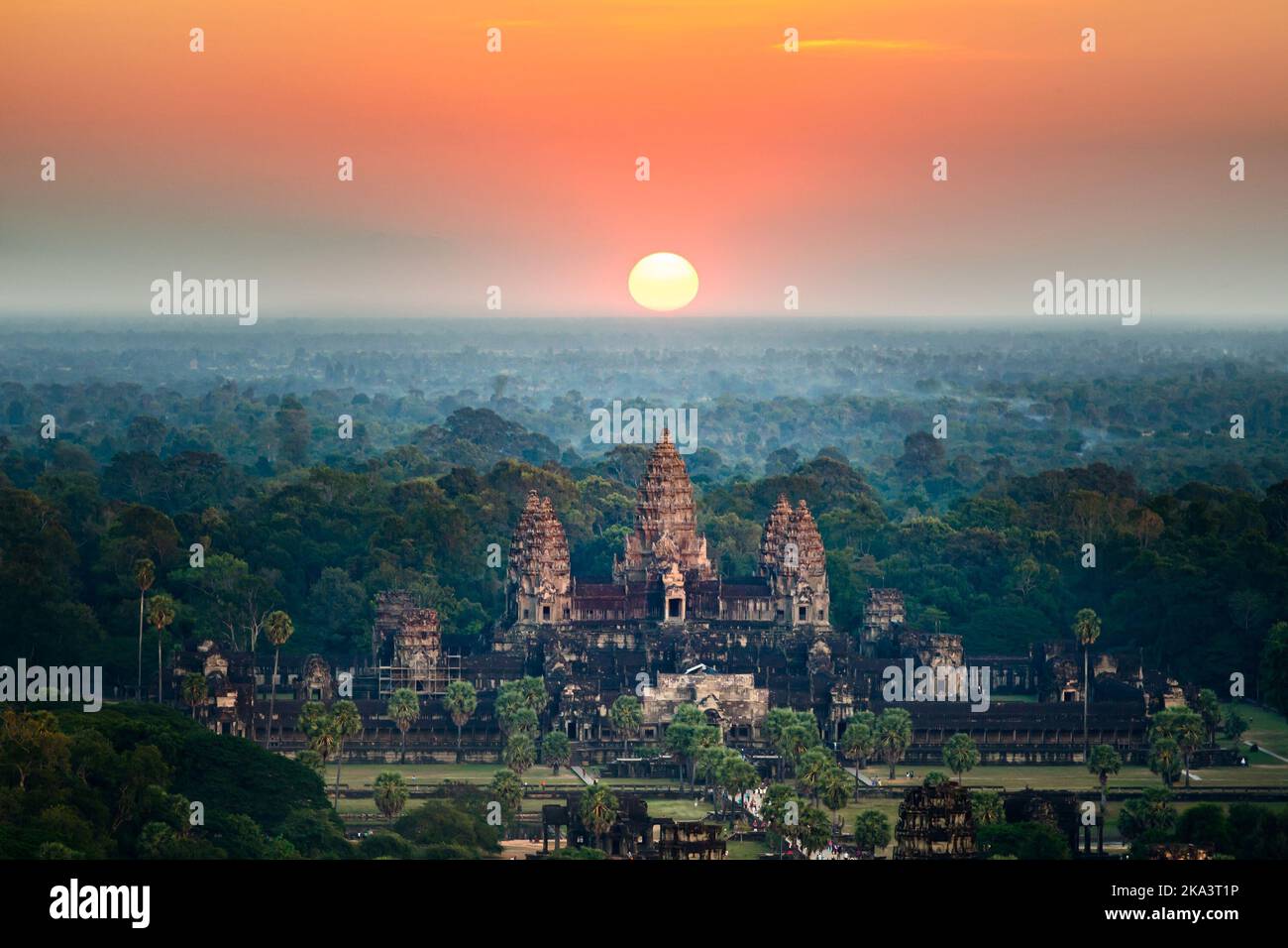 A bird's eye view of the Angkor Wat temple surrounded by greenery at ...