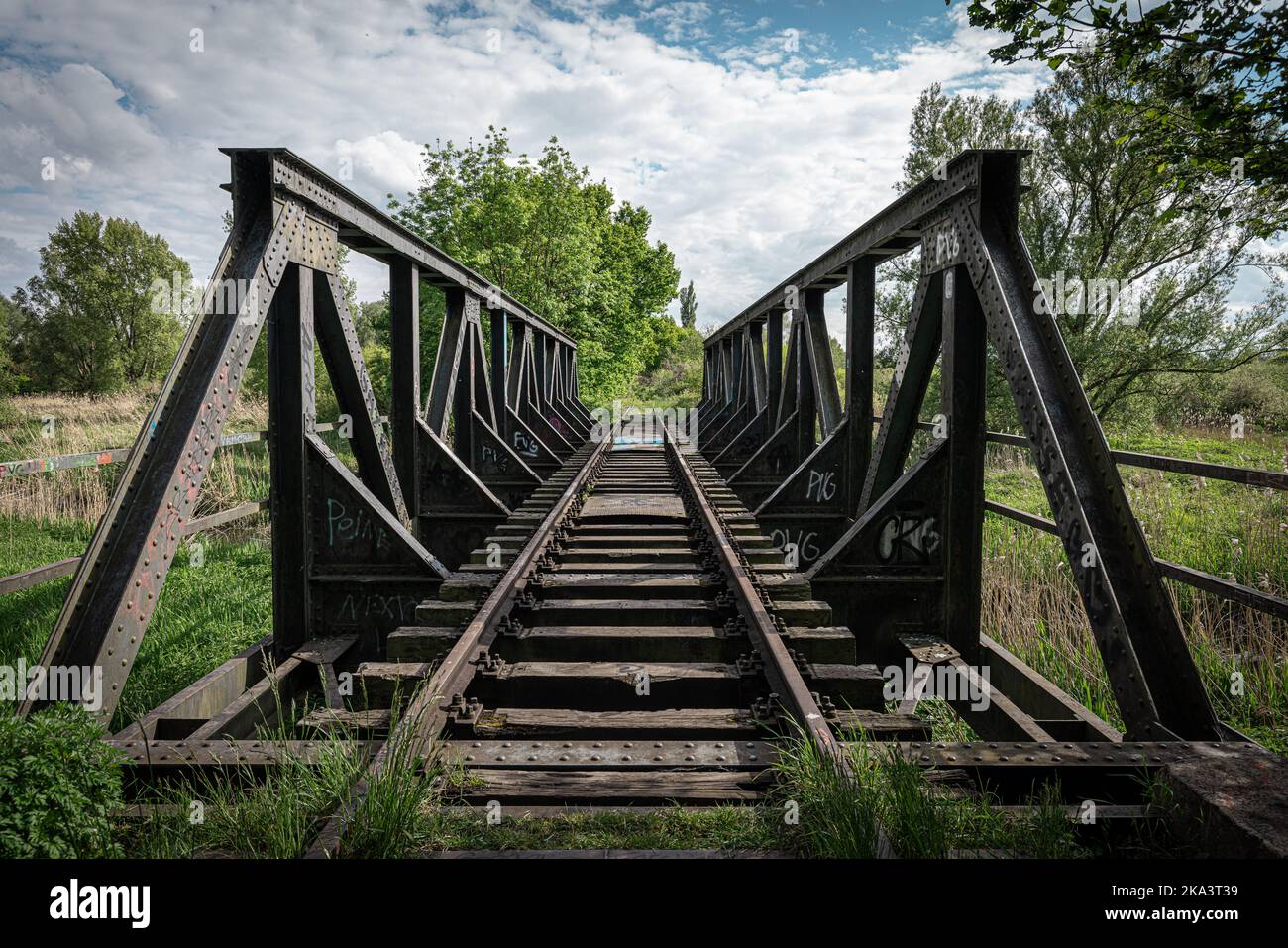 An abandoned rusty train bridge with railways in a natural environment ...