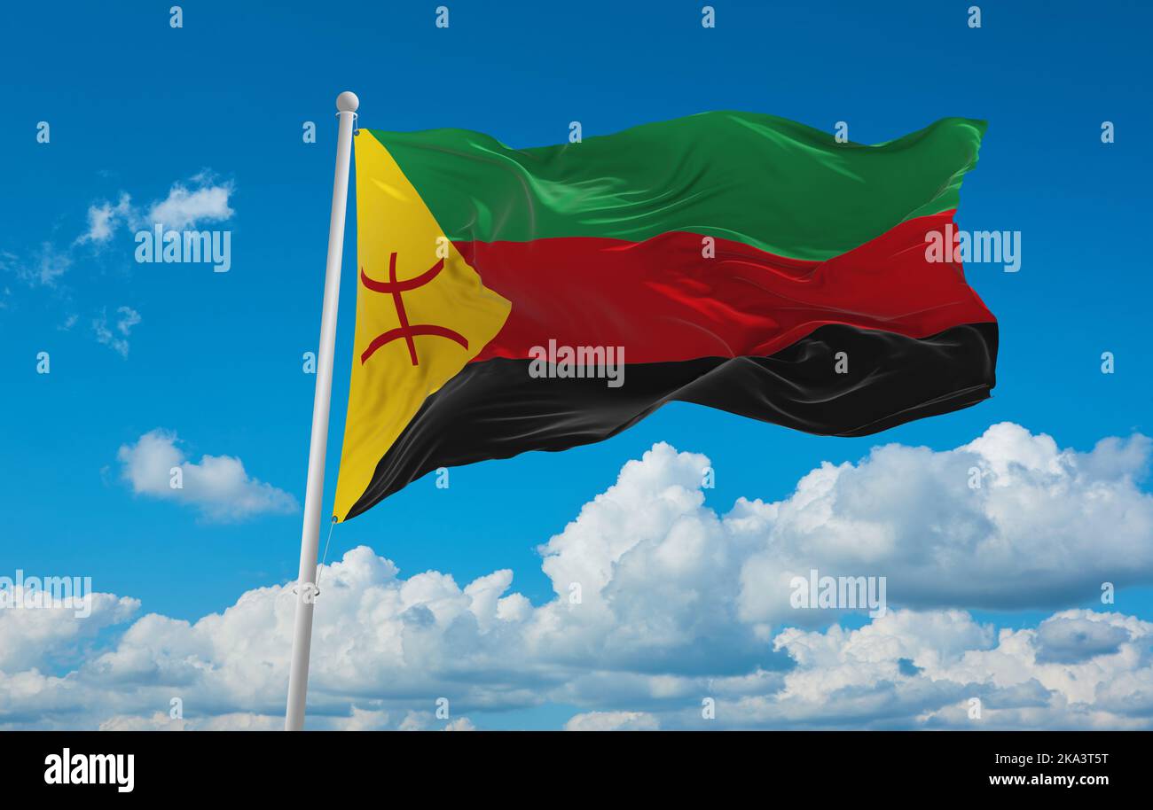 flag of Berbers Tuareg people at cloudy sky background, panoramic view ...