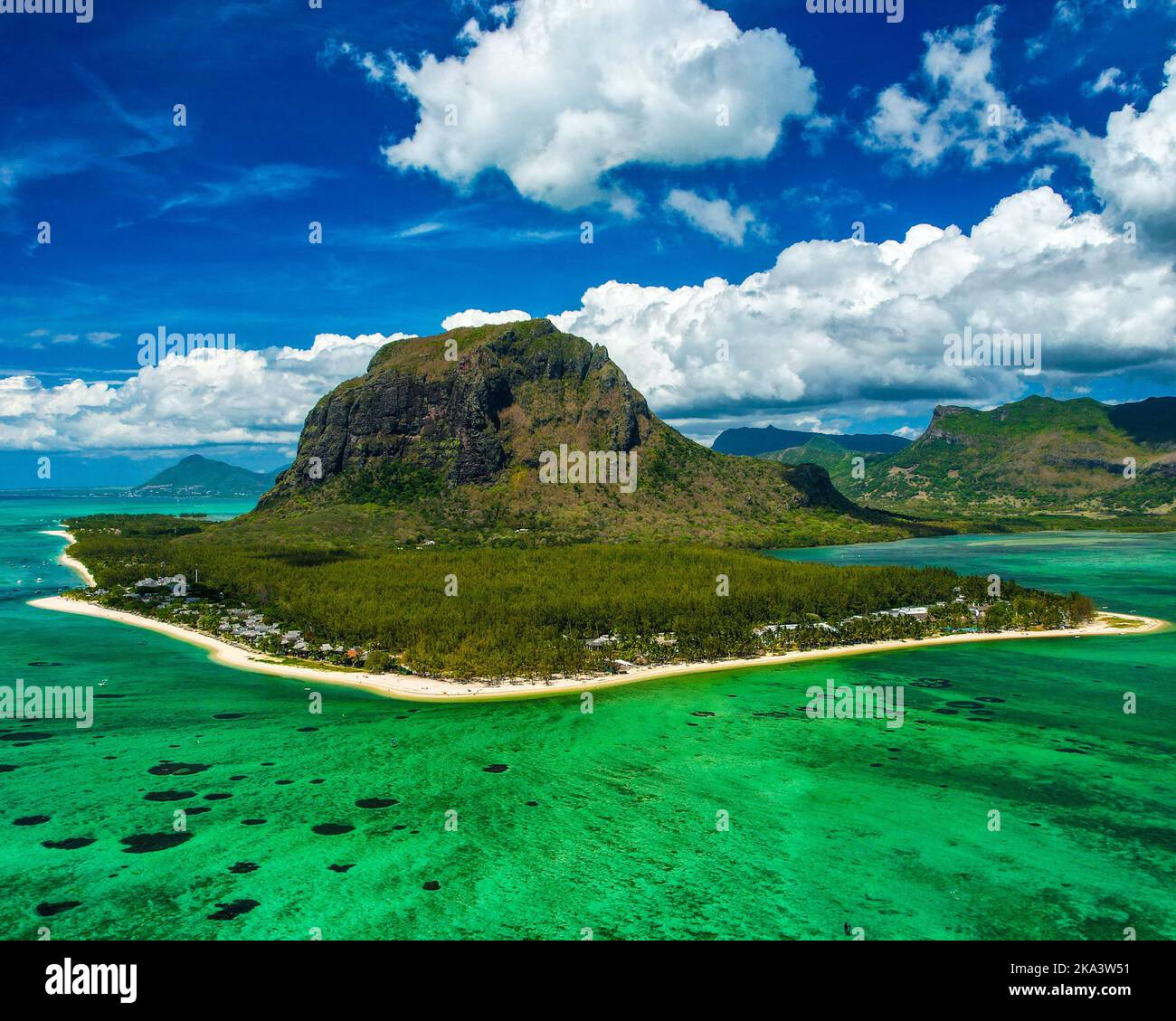 A scenic view of a small island with lush forests surrounded by the ...