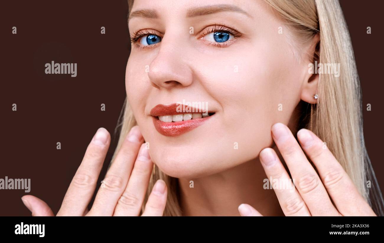 Face of beautiful smiling woman with natural makeup looking at camera ...