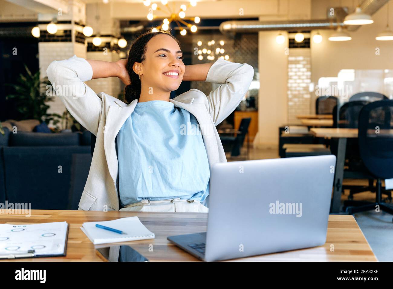 Happy calm brazilian or hispanic female employee resting during work ...