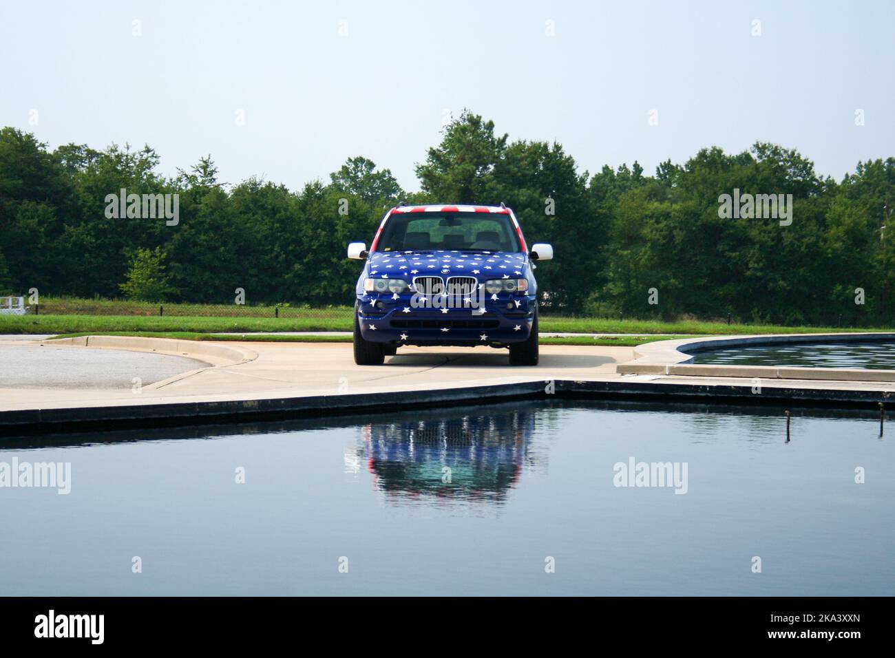 A 2006 BMW X5 (E53) car painted in the American Flag parked by a ...