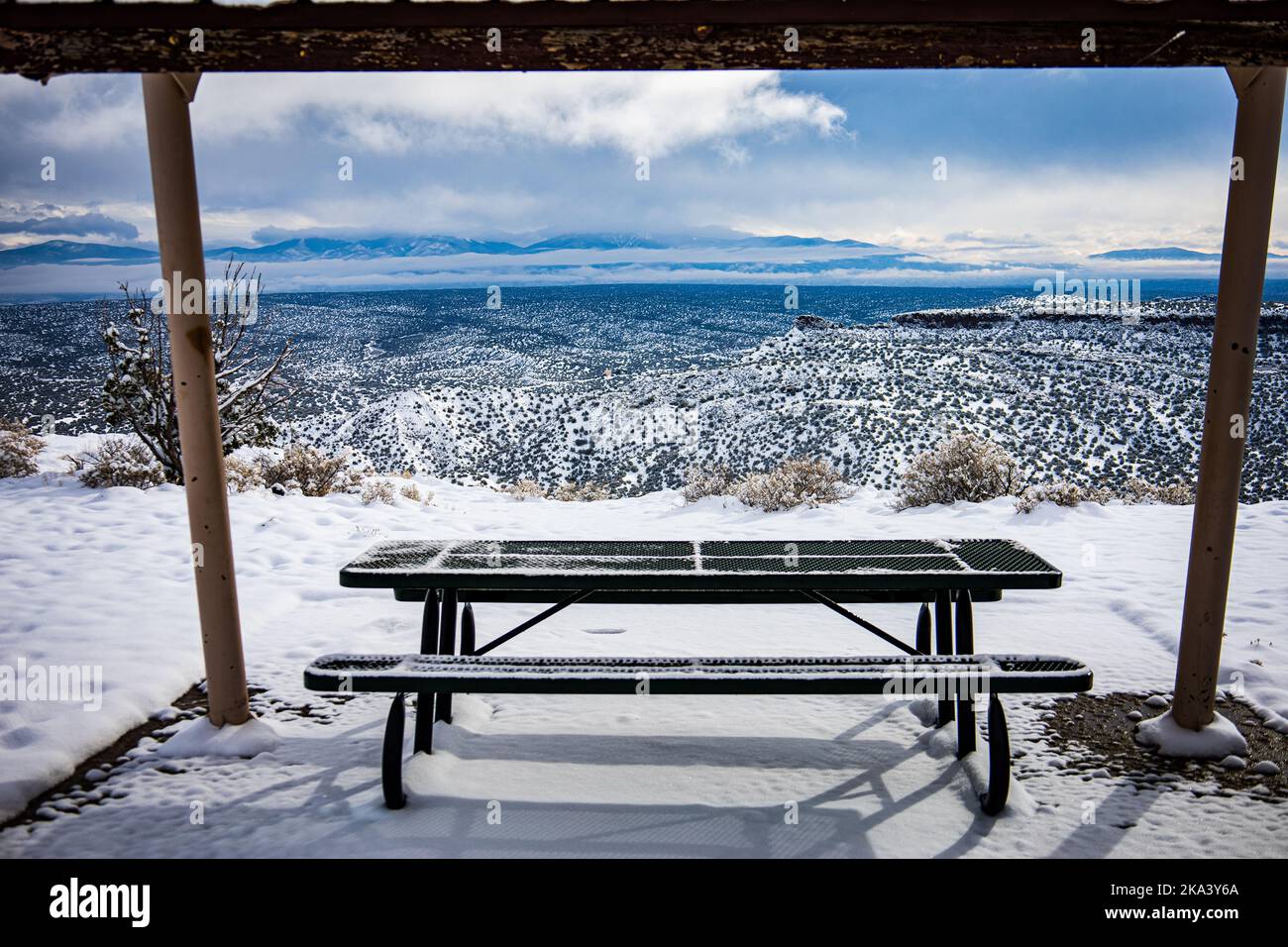 A bench looking out over snowy northern New Mexico, White Rock Overlook ...