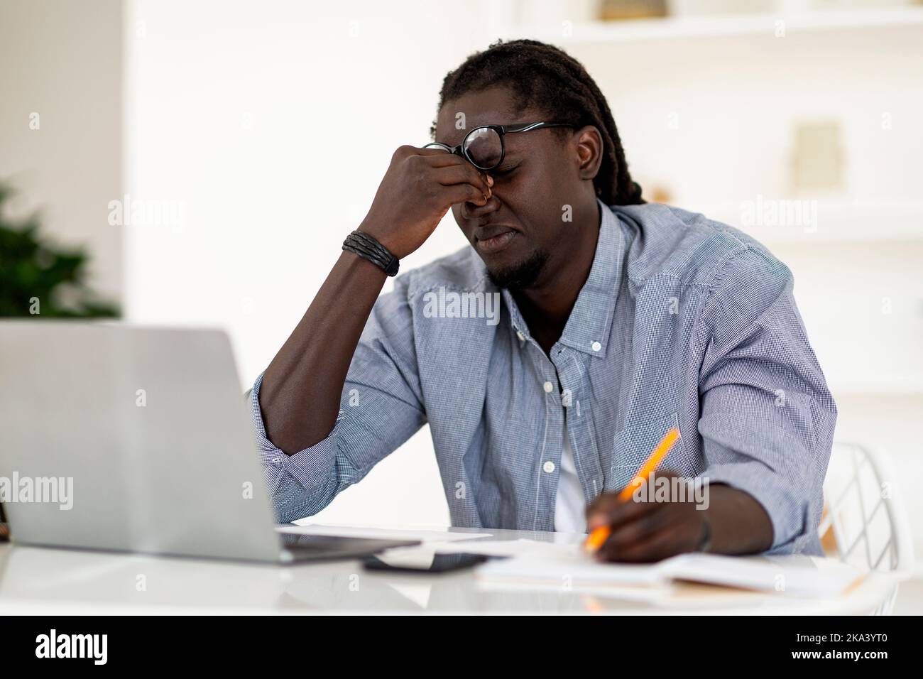 Tired Black Man Suffering Eye Strain While Working With Laptop At Desk ...