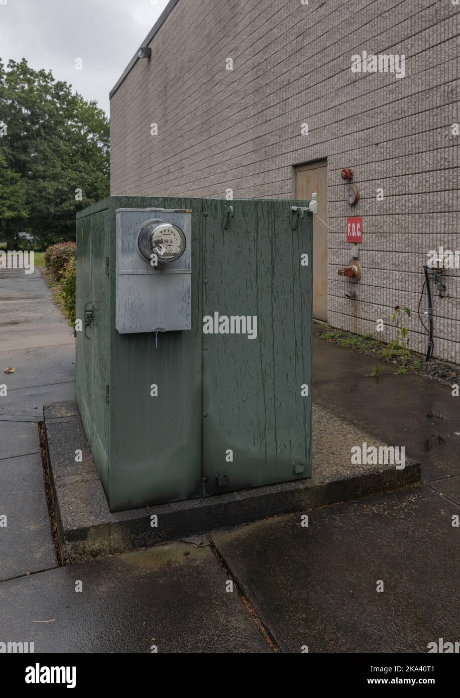 A vertical of the exterior of a green power box outside a commercial ...