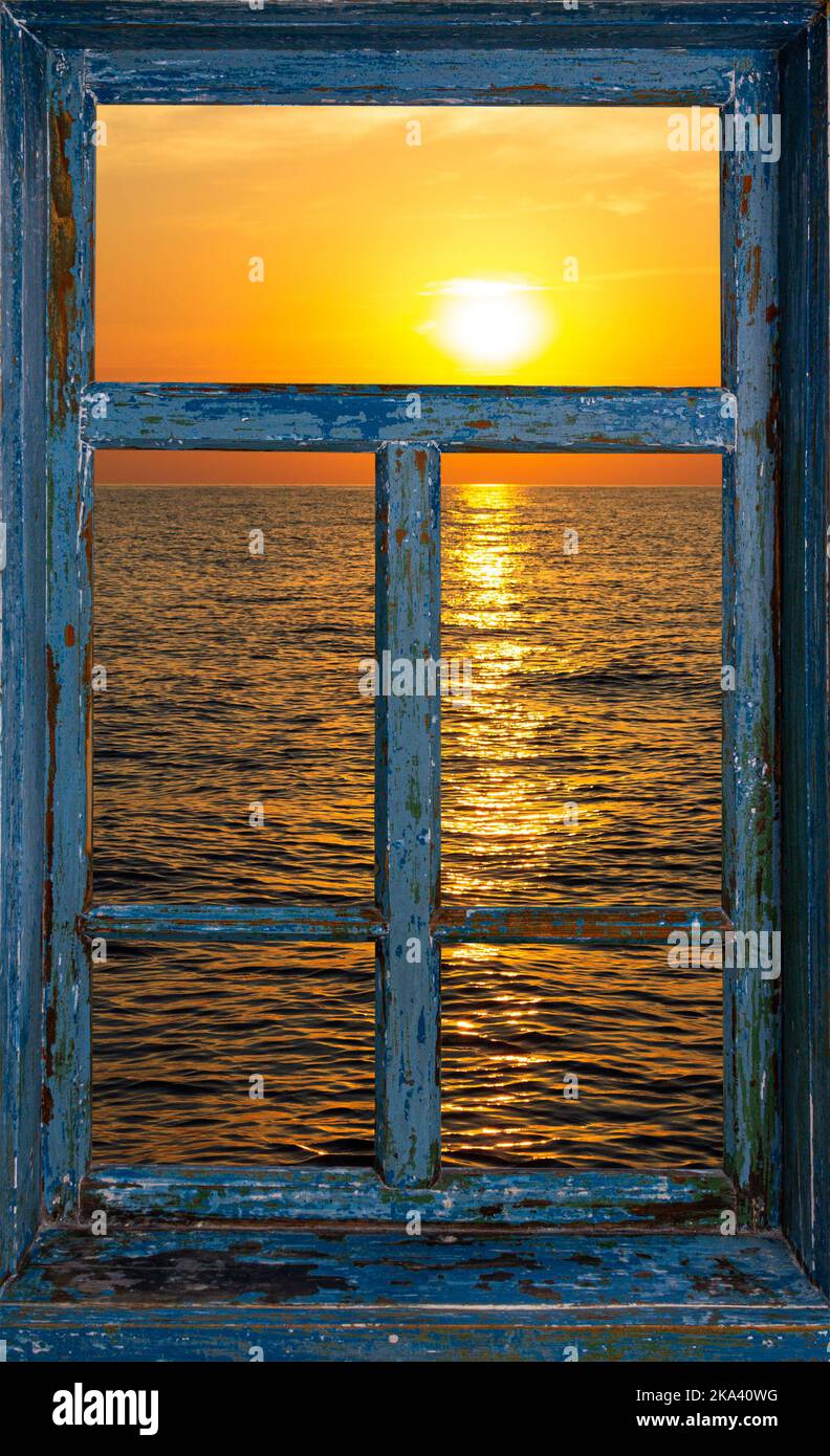 old window frame with remnants of blue paint with a beautiful sea ...