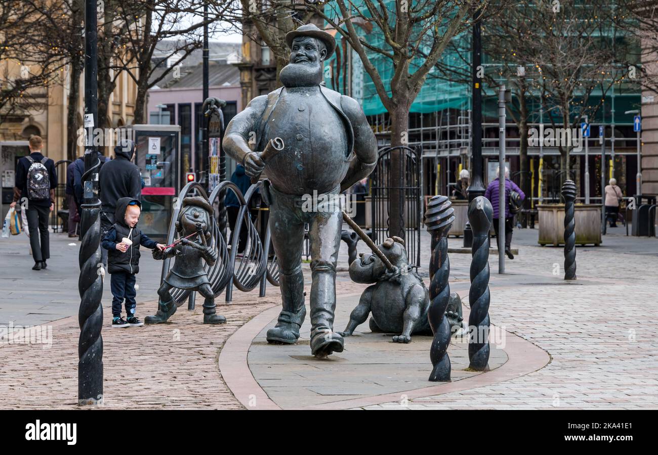 Child looking at quirky bronze sculpture of Beano comic strip character ...
