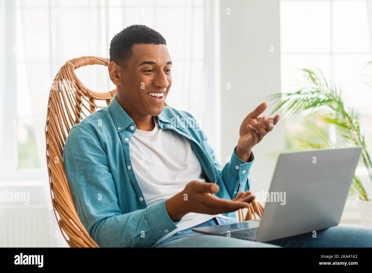 Cheerful young african american man has video call on computer ...