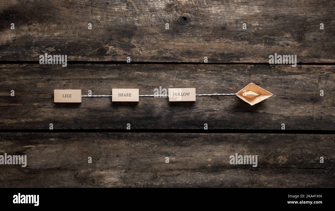 Paper made origami boat pulling three wooden pegs with a Like, Share ...
