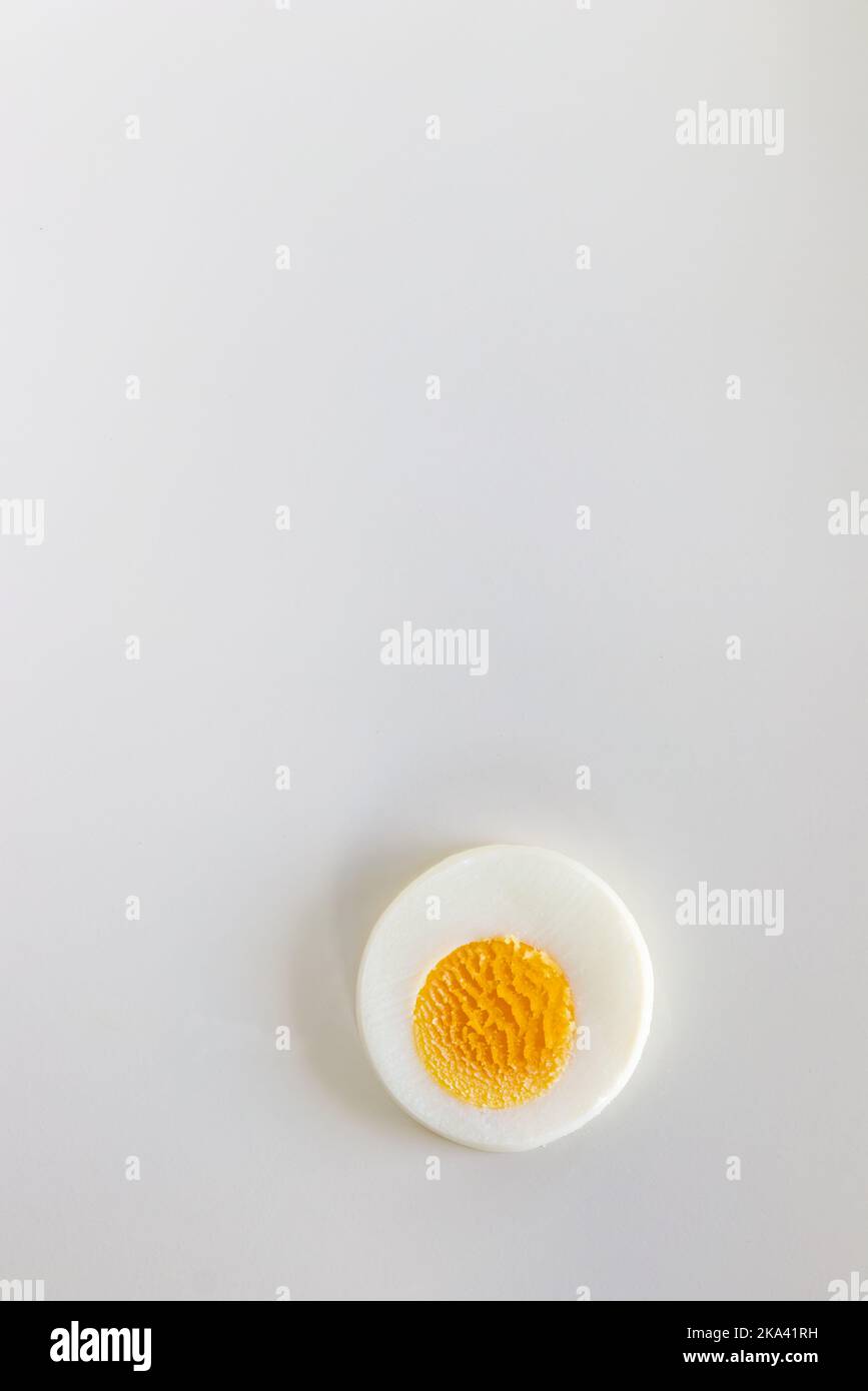 Single hard boiled egg slice on white background Stock Photo - Alamy