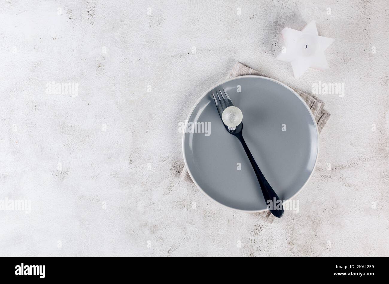 Christmas table setting. Top view of empty grey plate with black ...