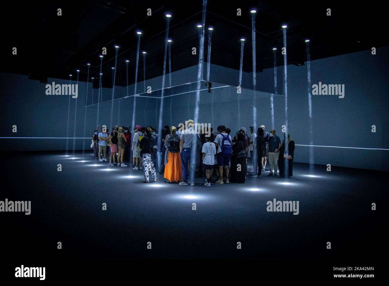 down lights on group of people in dark room low light Stock Photo - Alamy