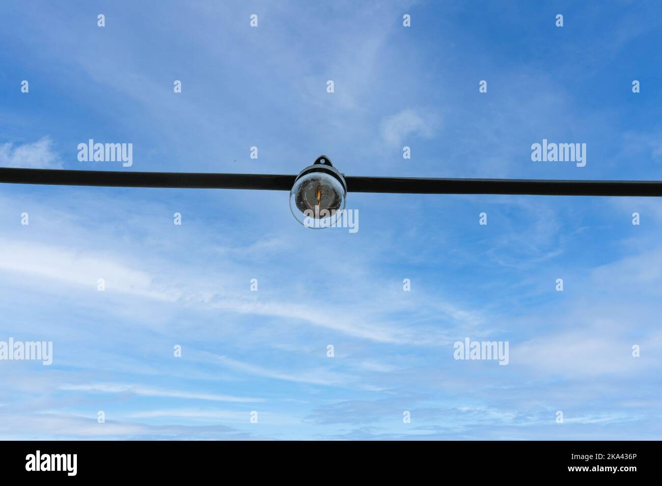 overhead light bulb against blue sky Stock Photo - Alamy