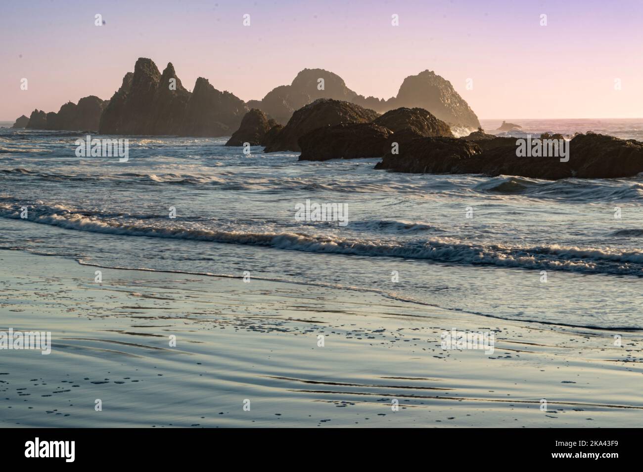 Sunrise or Sunset over the Oregon Coastline, with waves washing over ...