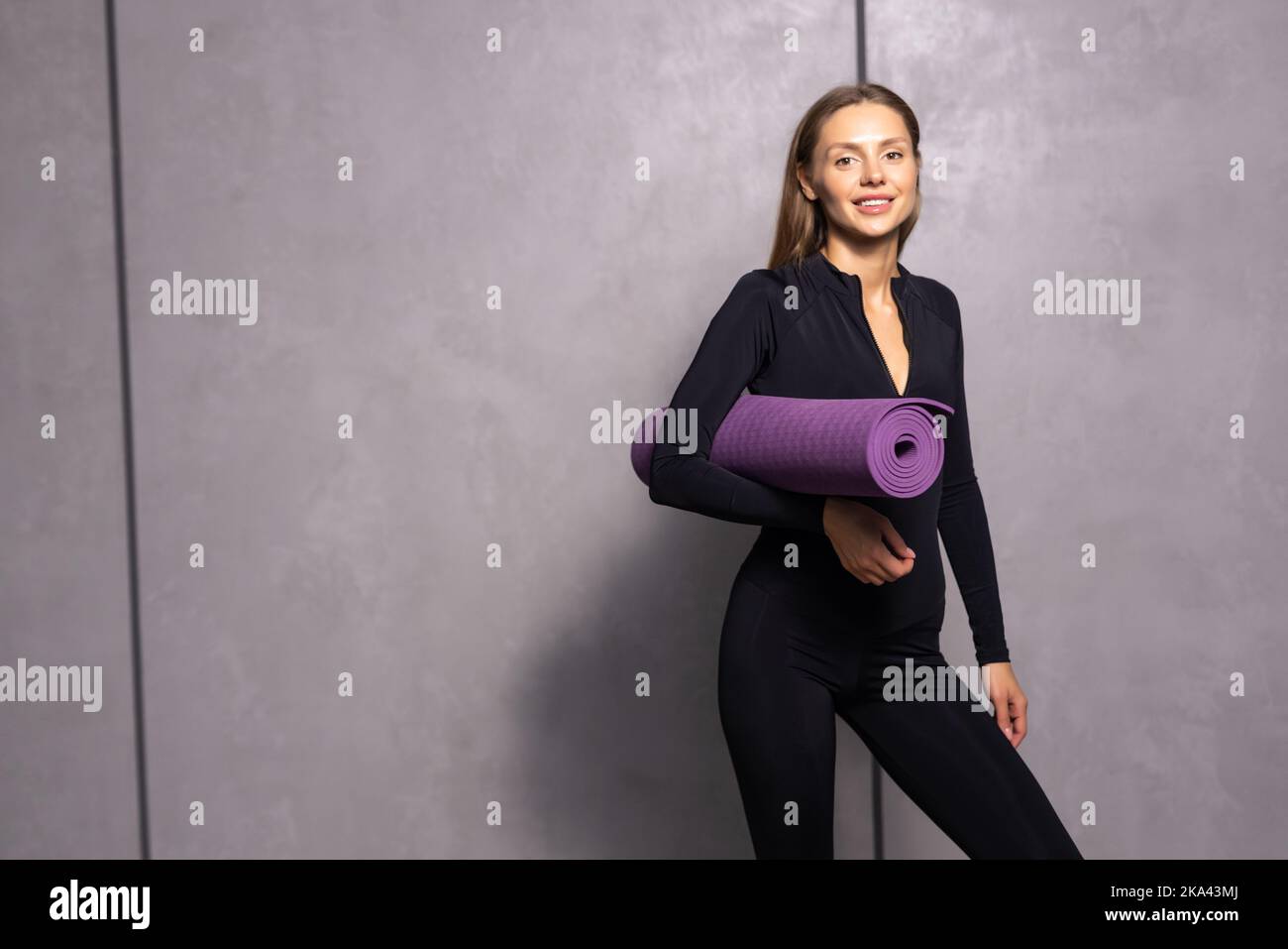 Full length shot of slim woman with fitness body, wears top, leggings ...