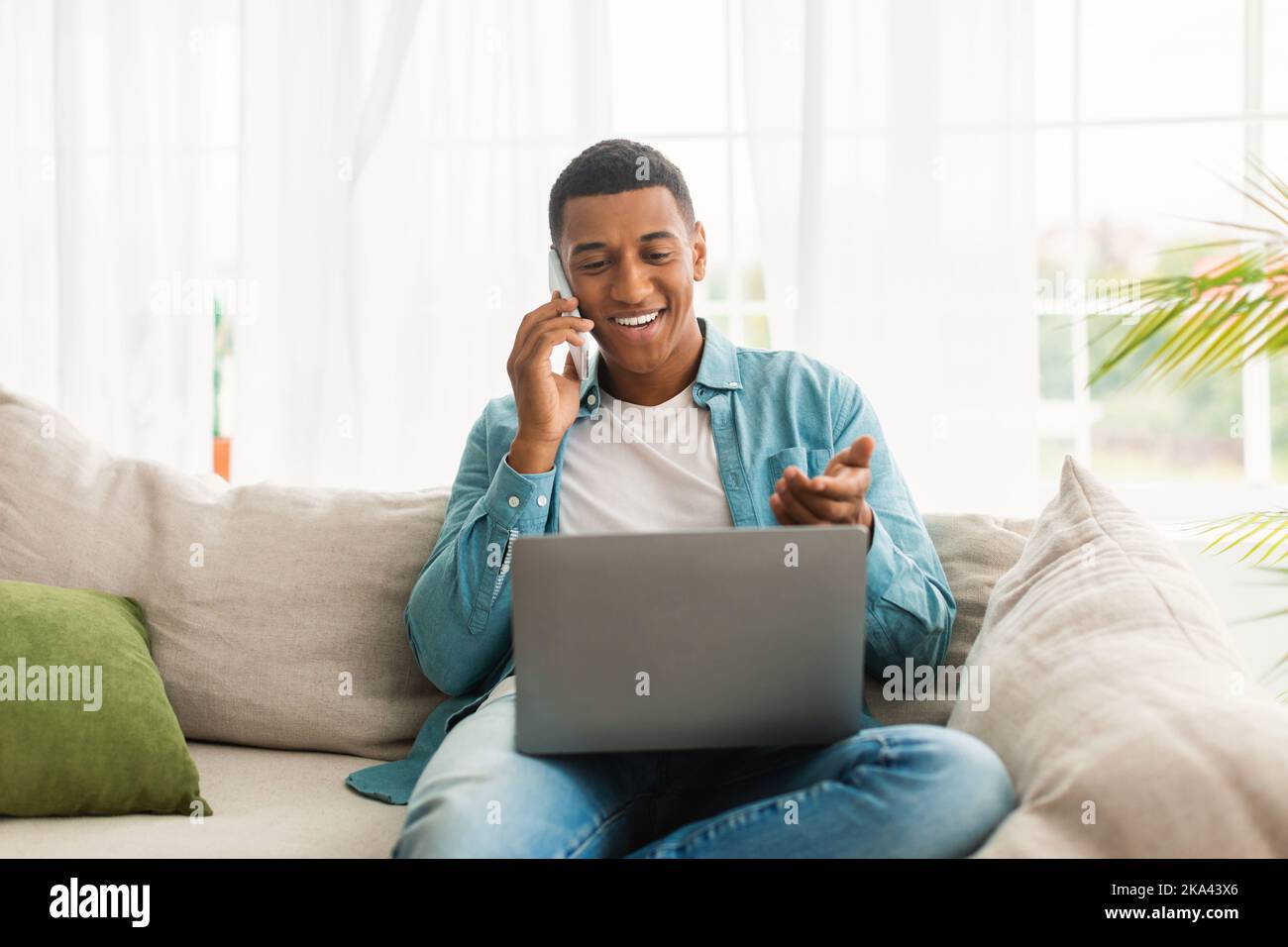 Happy busy millennial african american male calling by smartphone ...