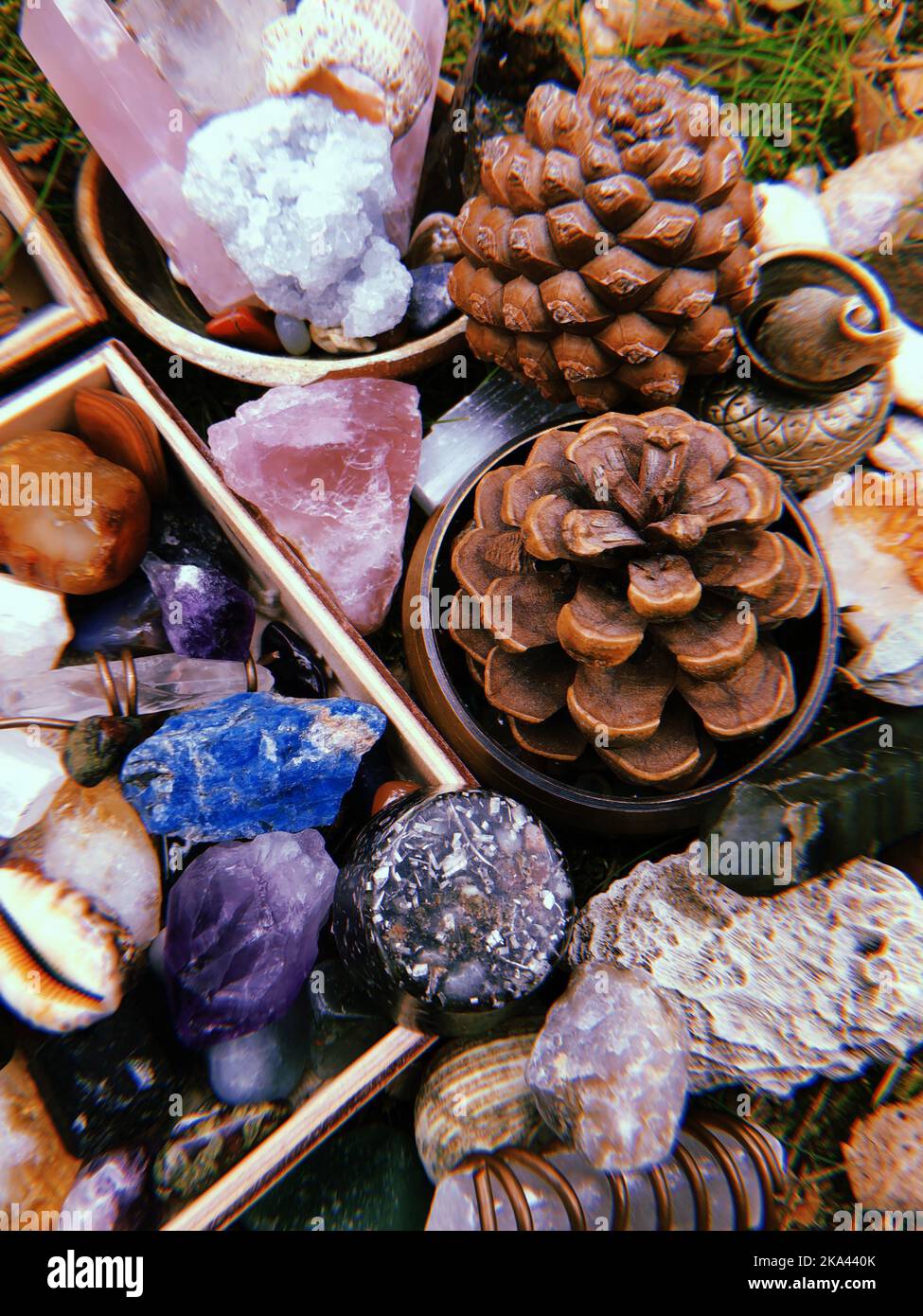 A top view of pine cones and colorful crystal healing stones for ...