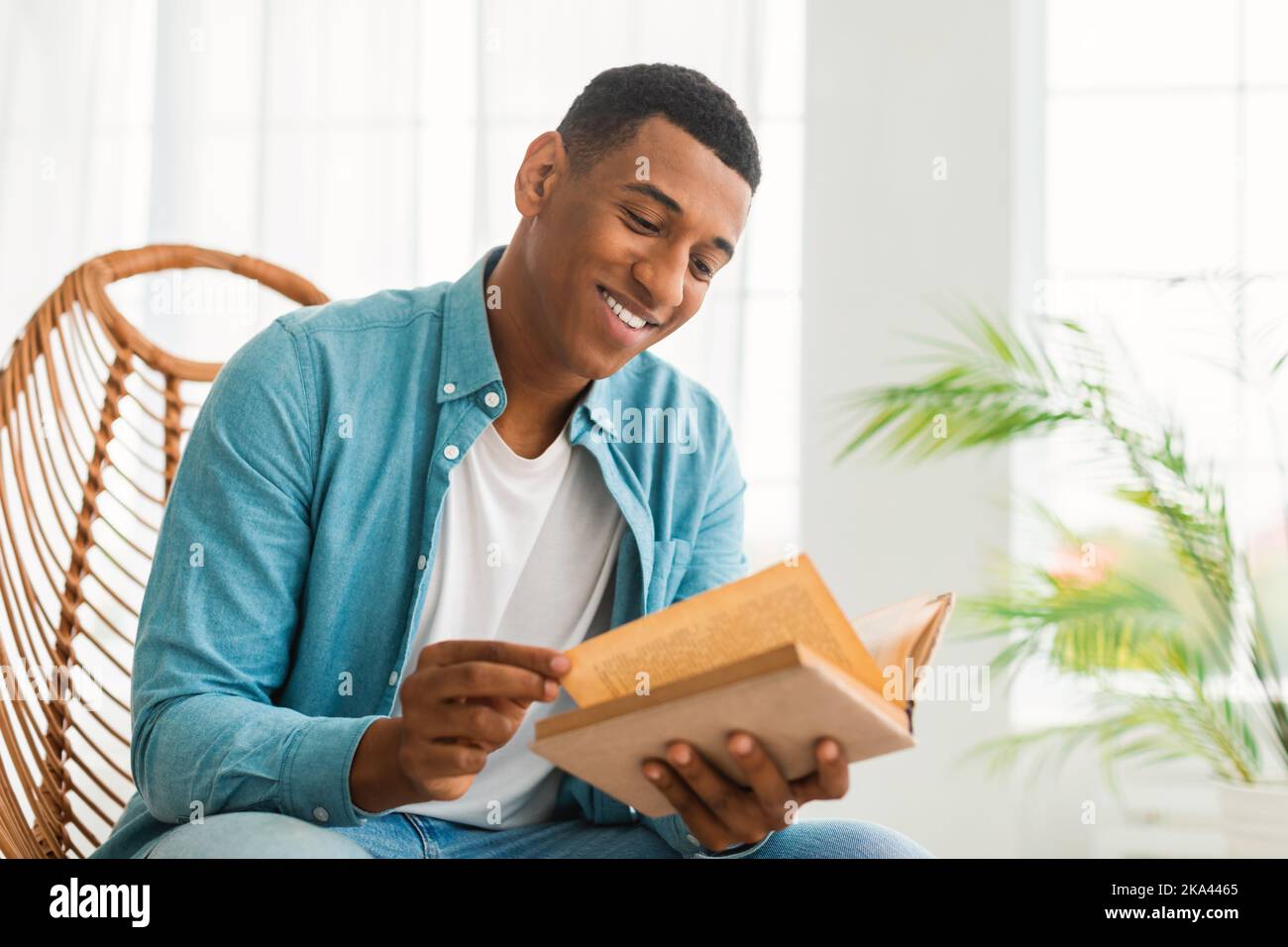 Smiling Smart Millennial African American Guy Reading Book Sit On
