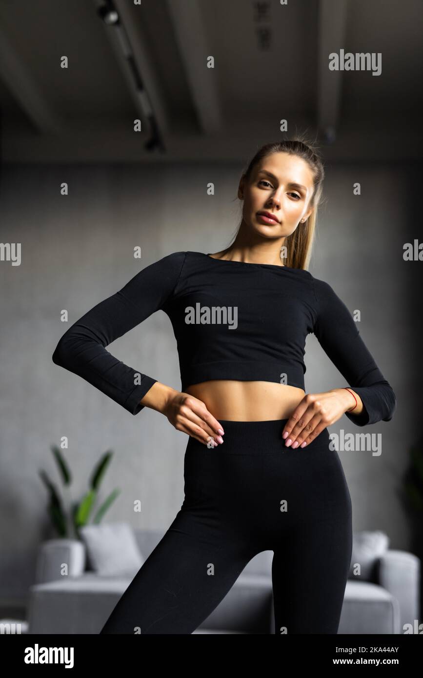 A woman is engaged in aerobics with her health doing stretching and ...