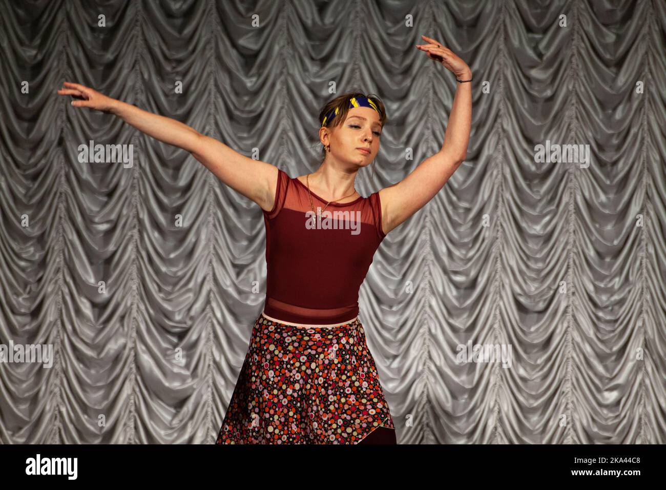 Girl dancing on stage. Ballerina performs. Dance lesson in hall ...