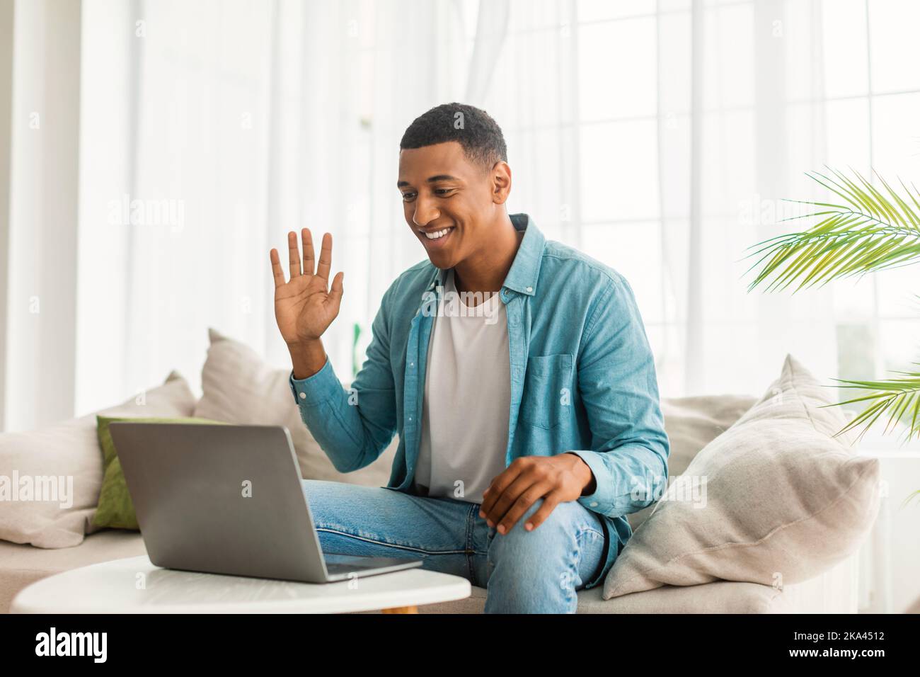 Man waving at computer hi-res stock photography and images - Alamy