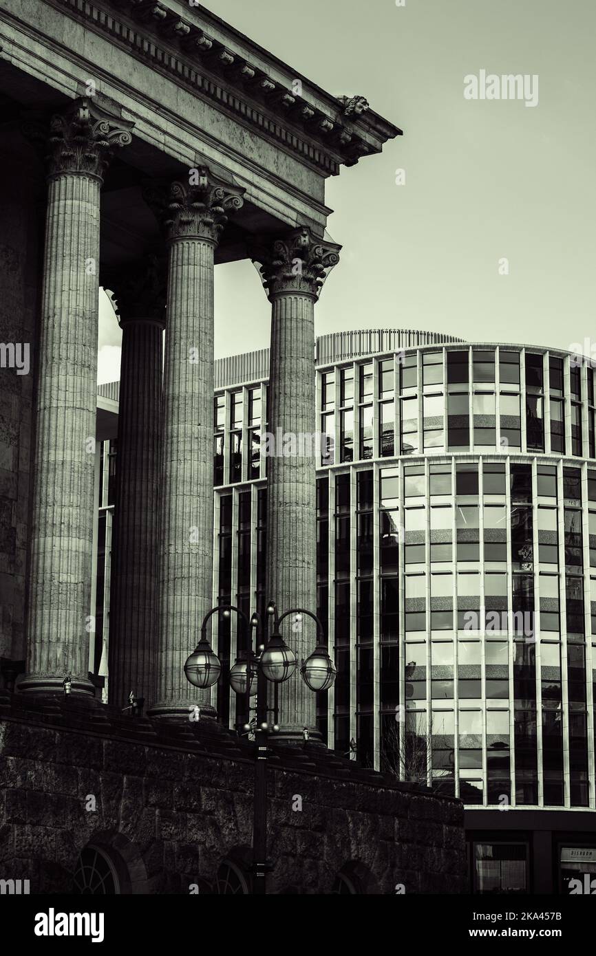 The vertical grayscale shot of a peripteros style building with high ...